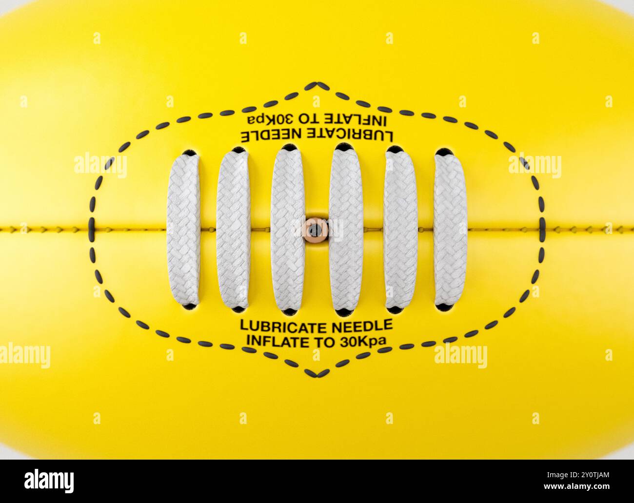 A generic unbranded yellow aussie rules football ball on an isolated ...