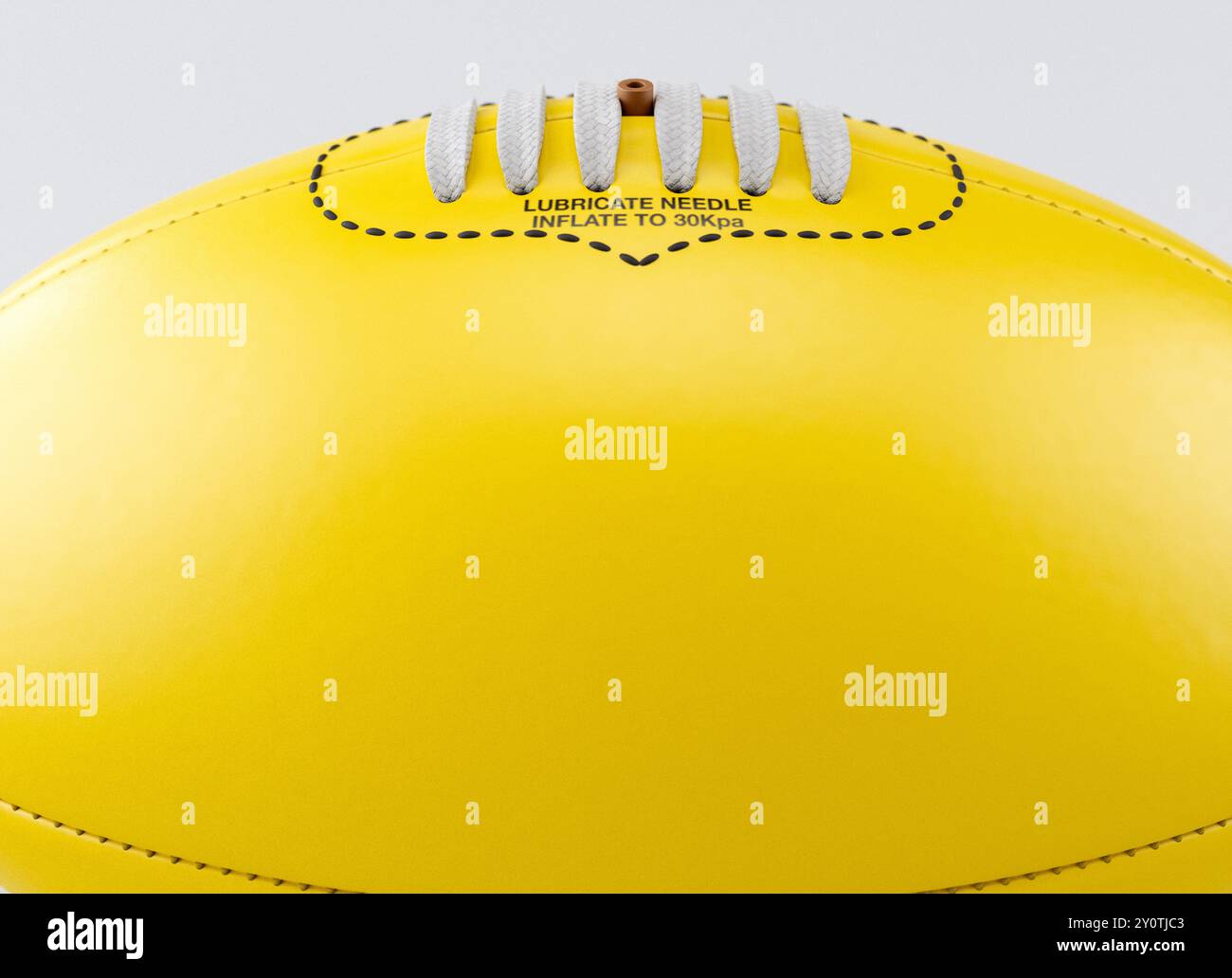 A generic unbranded yellow aussie rules football ball on an isolated ...