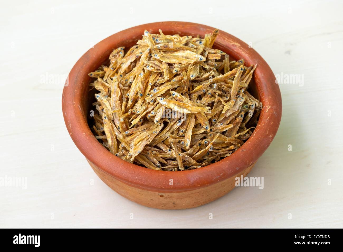 A pile of dried fish in an earthen pot. Locally In Bangladesh, It is ...