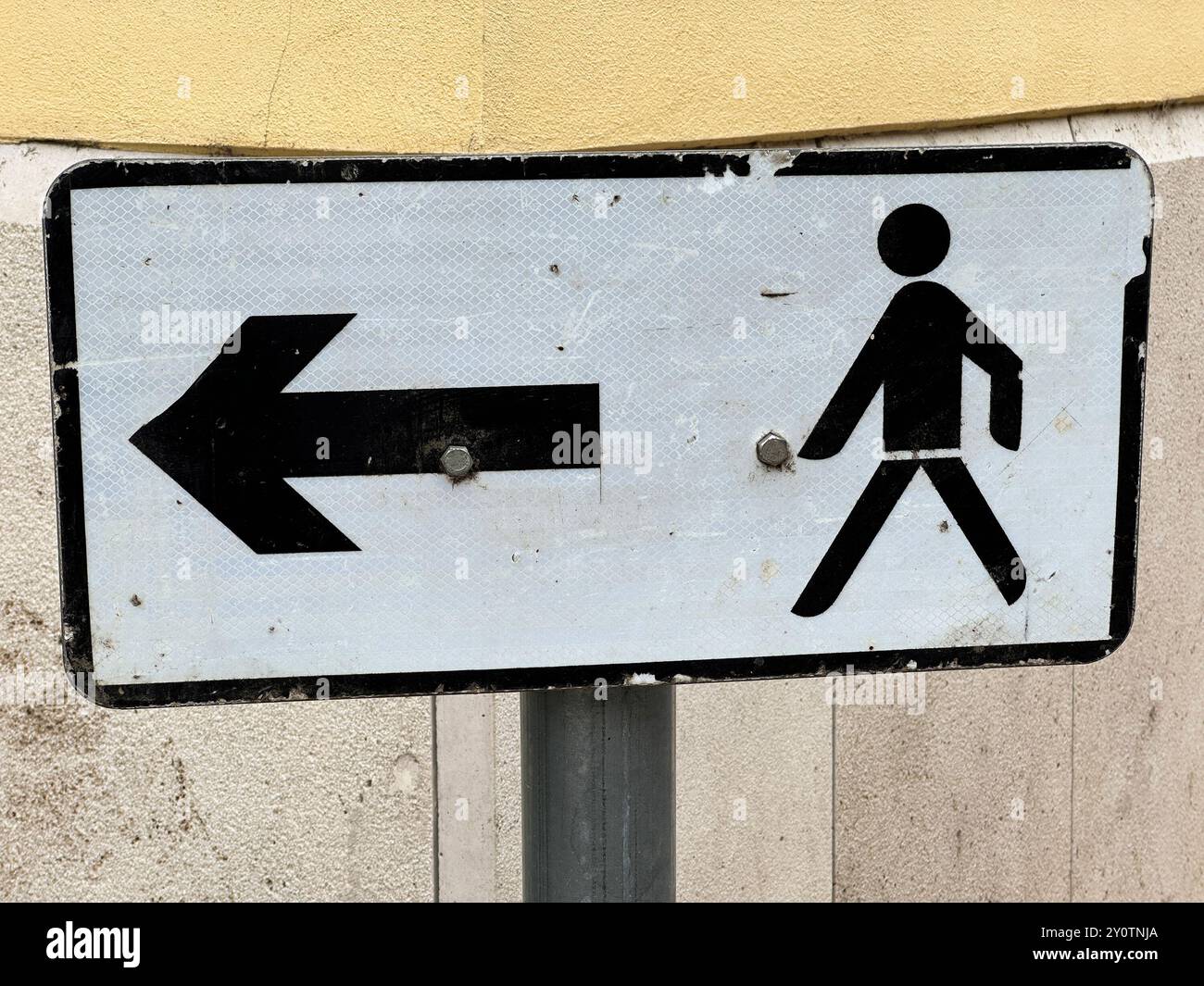 Exit arrow sign with pictogram on the street Stock Photo - Alamy