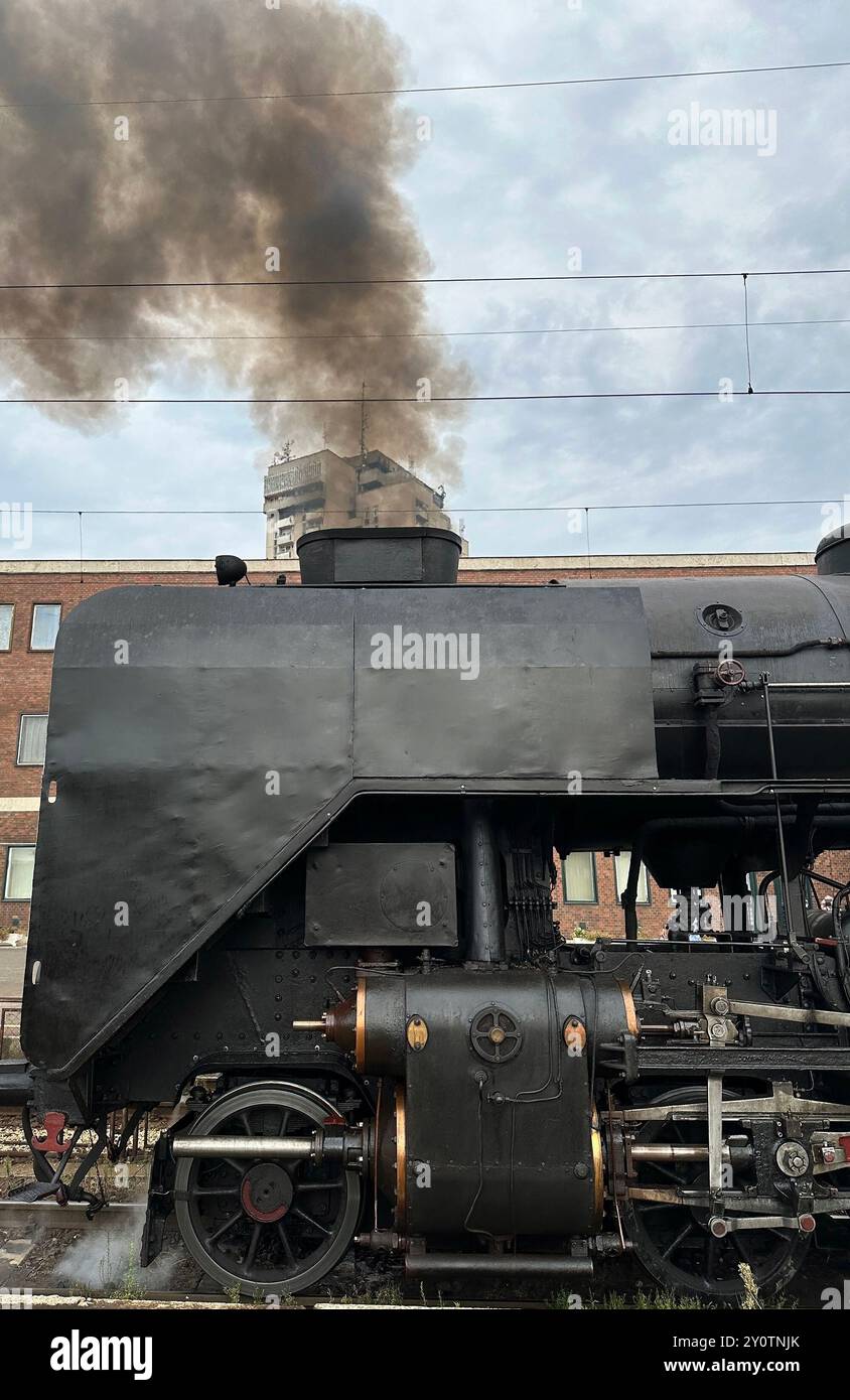 Old smoking locomotive at the station platform Stock Photo - Alamy