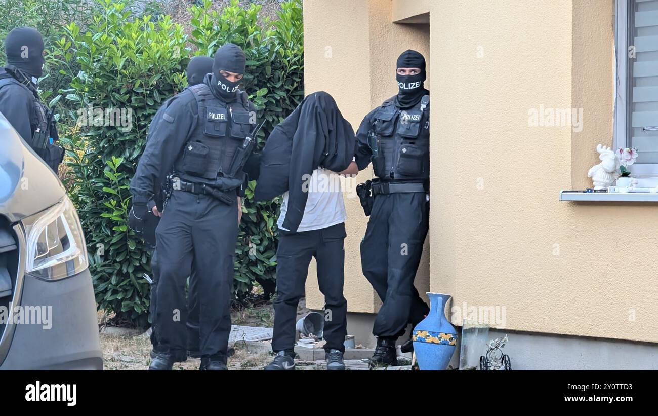 Jena, Germany. 04th Sep, 2024. Police officers lead a suspect away ...