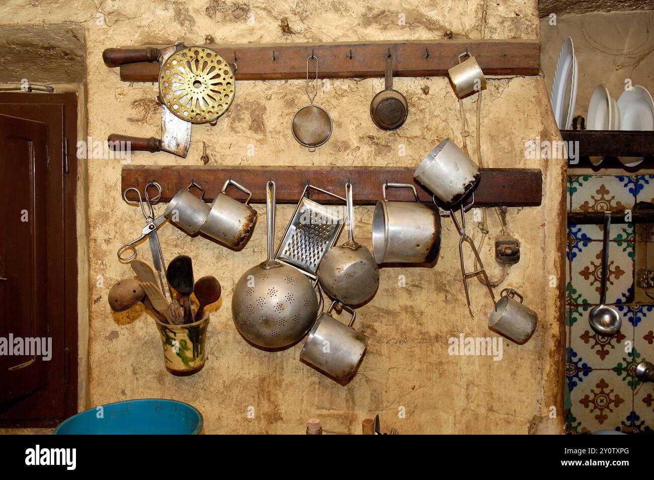 old hanging kitchen utensils Stock Photo - Alamy