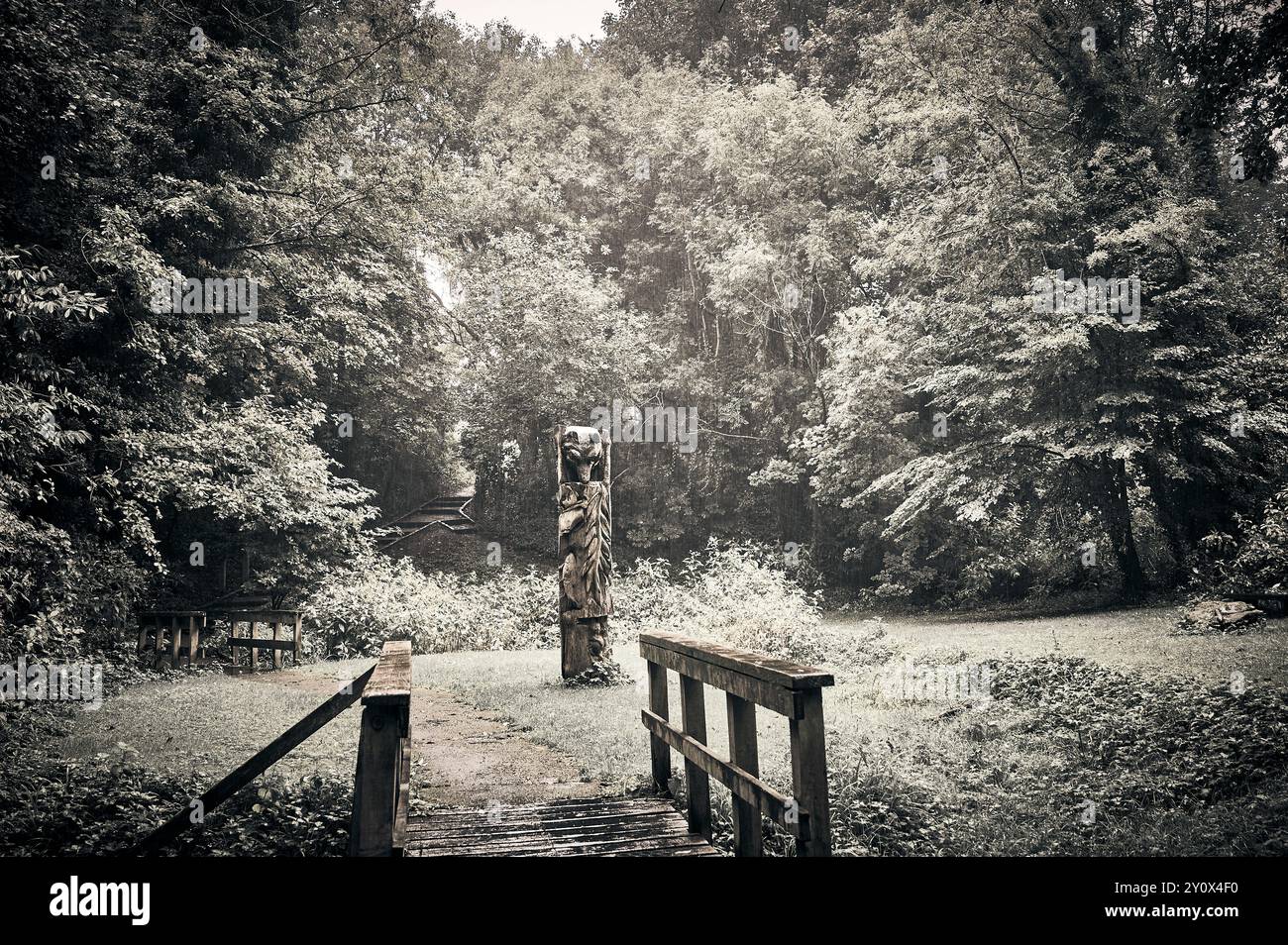 Totum pole and small wooden bridge Stock Photo - Alamy