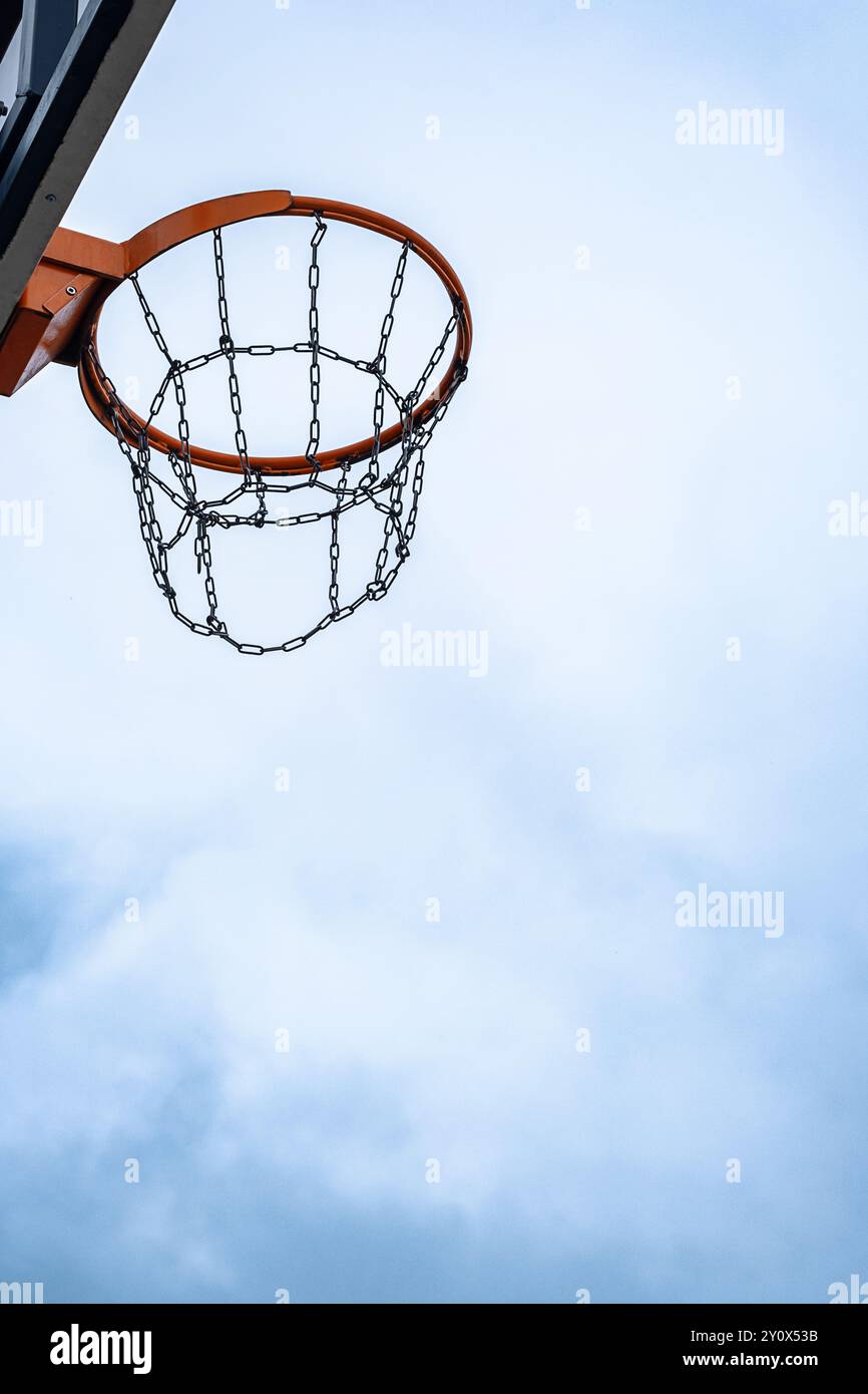 Outdoor basketball hoop with chain net against cloudy sky Stock Photo ...