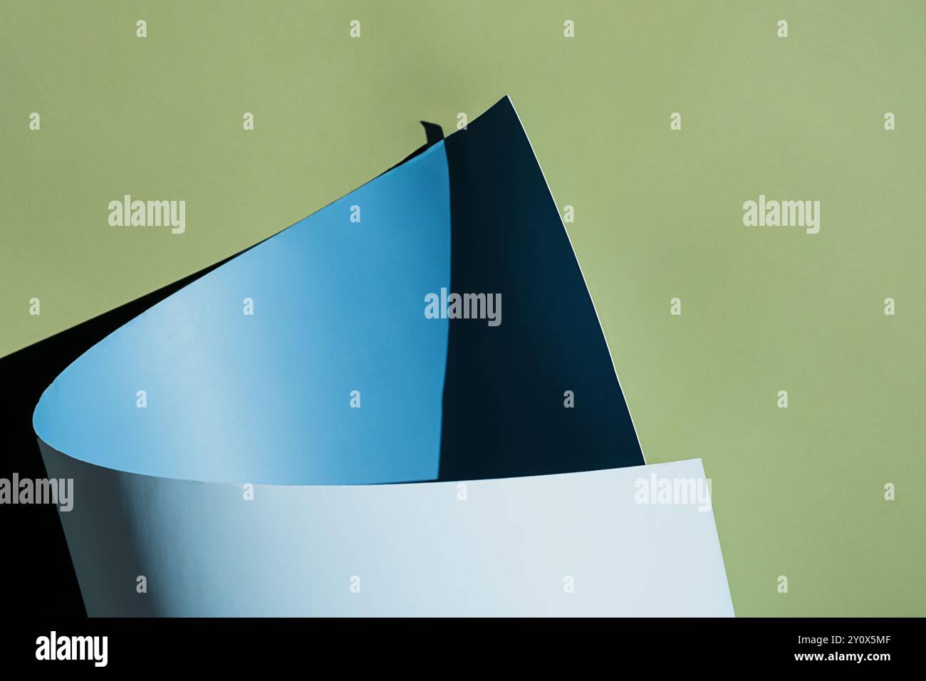 Abstract composition with curved blue and green paper curves and ...