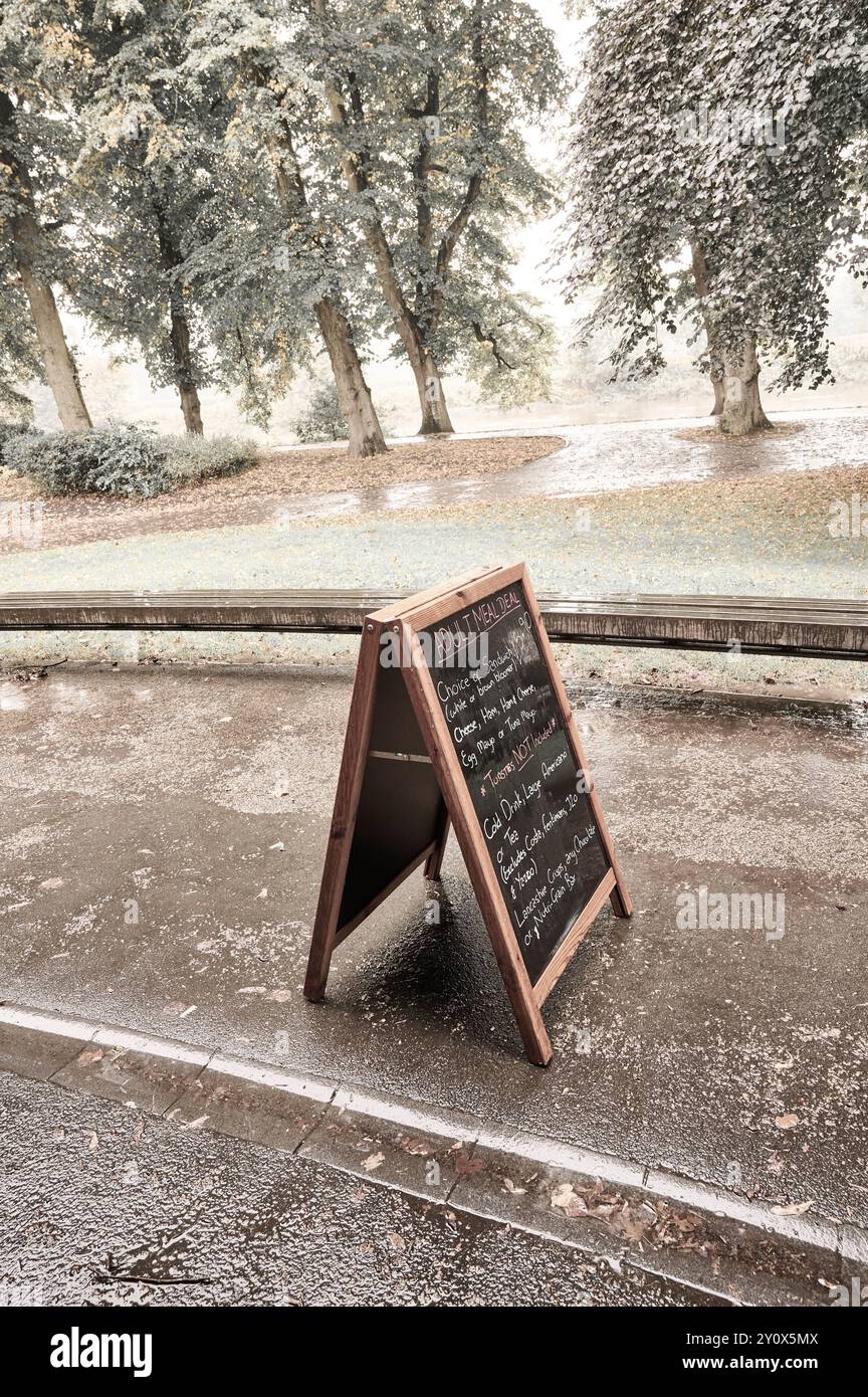 Menu board outside park cafe in the rain Stock Photo - Alamy