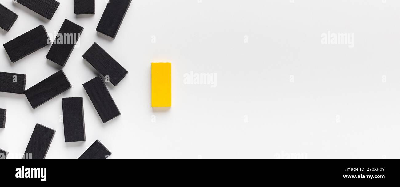 Yellow block standing out of black ones Stock Photo - Alamy