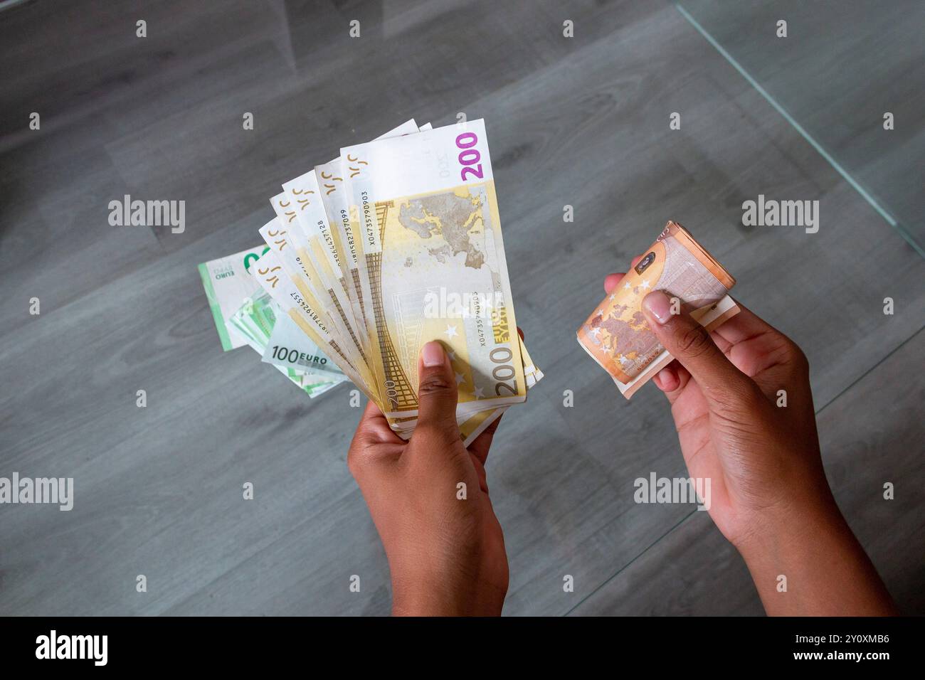 Euro bills of different amounts handed over by one hand. Concept ...