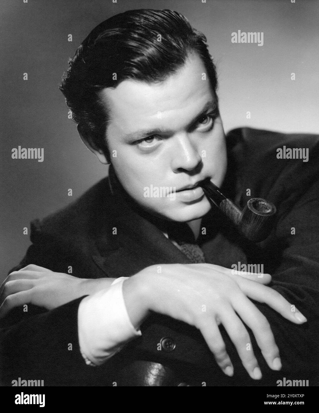 Portrait of Hollywood star Orson Welles, smoking a pipe - publicity ...