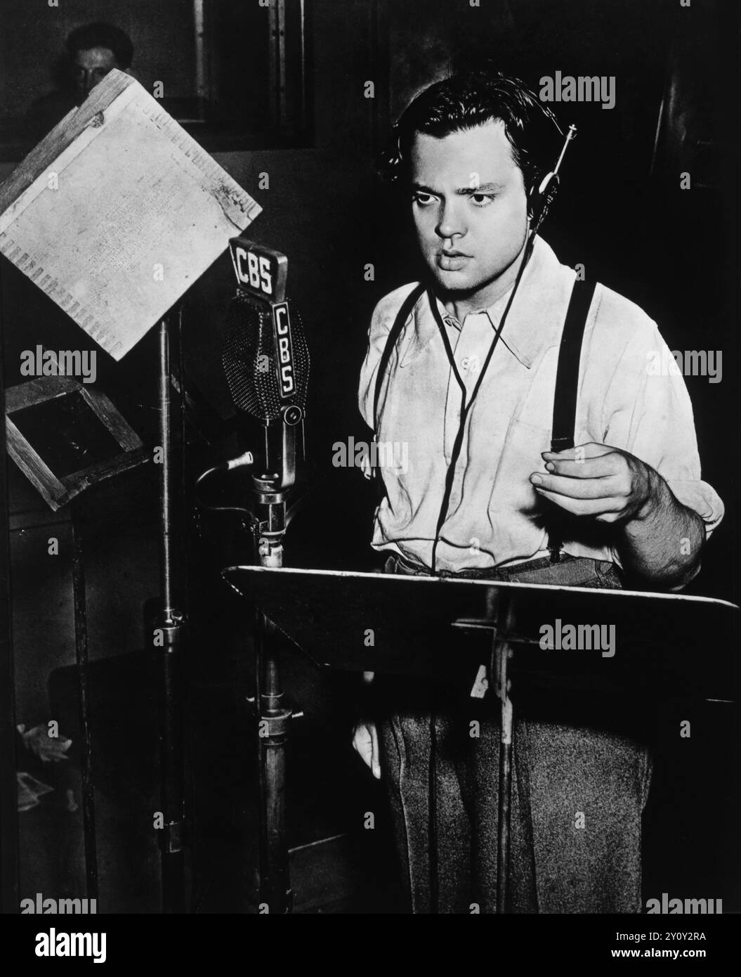 Orson Welles at work in the CBS Radio studio, used in a feature story ...
