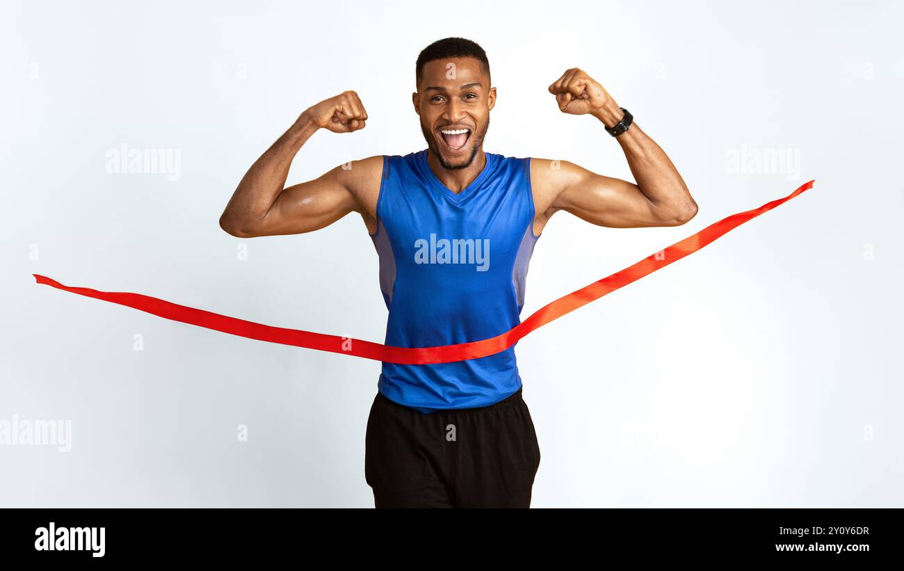 Happy black man celebrating success breaking finish rope Stock Photo ...