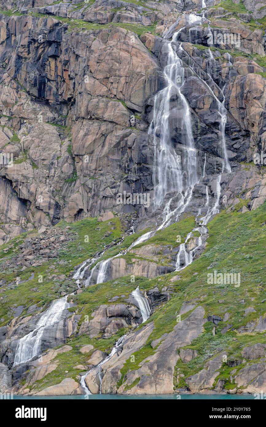 a waterfall cascades into Prince Christian Sound, Greenland Stock Photo ...