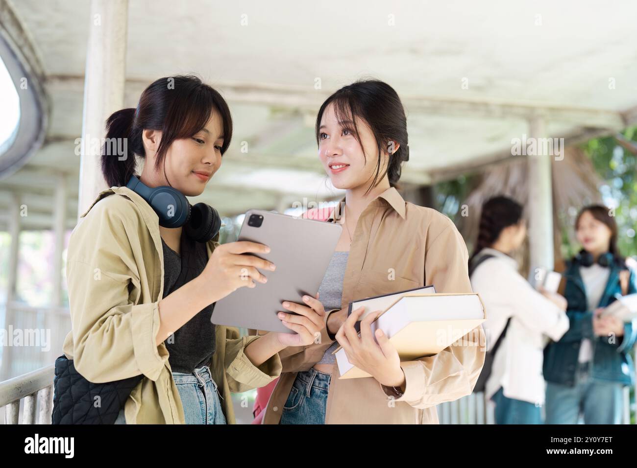 University Students Studying Together Outdoors with Books and Tablet ...