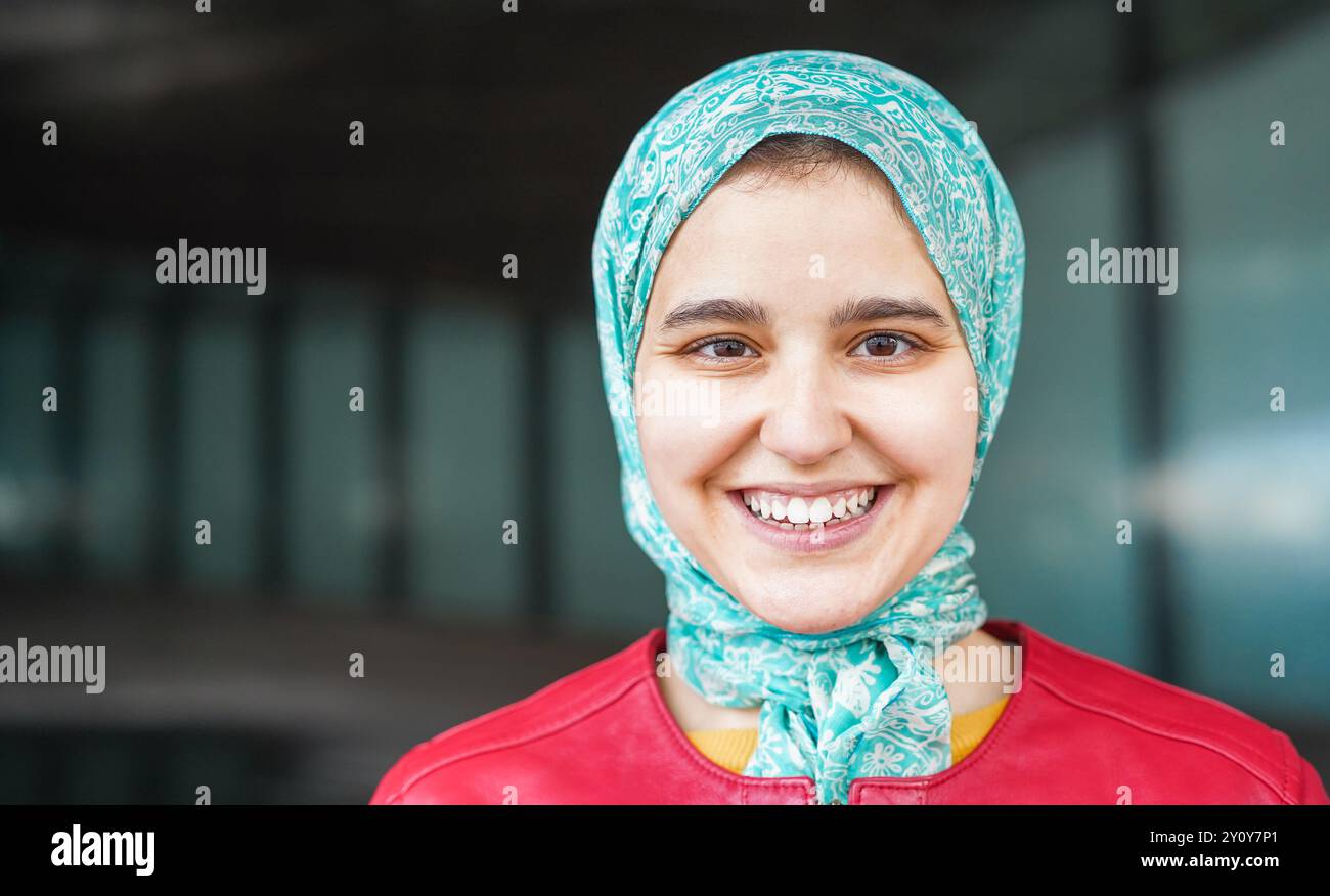 Young arabian girl wearing hijab while smiling outdoor during fall ...