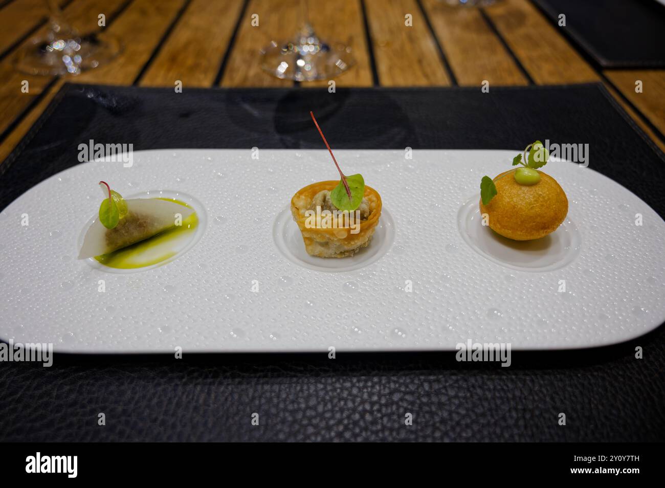 Gourmet plated appetizers served on a modern white dish Stock Photo - Alamy