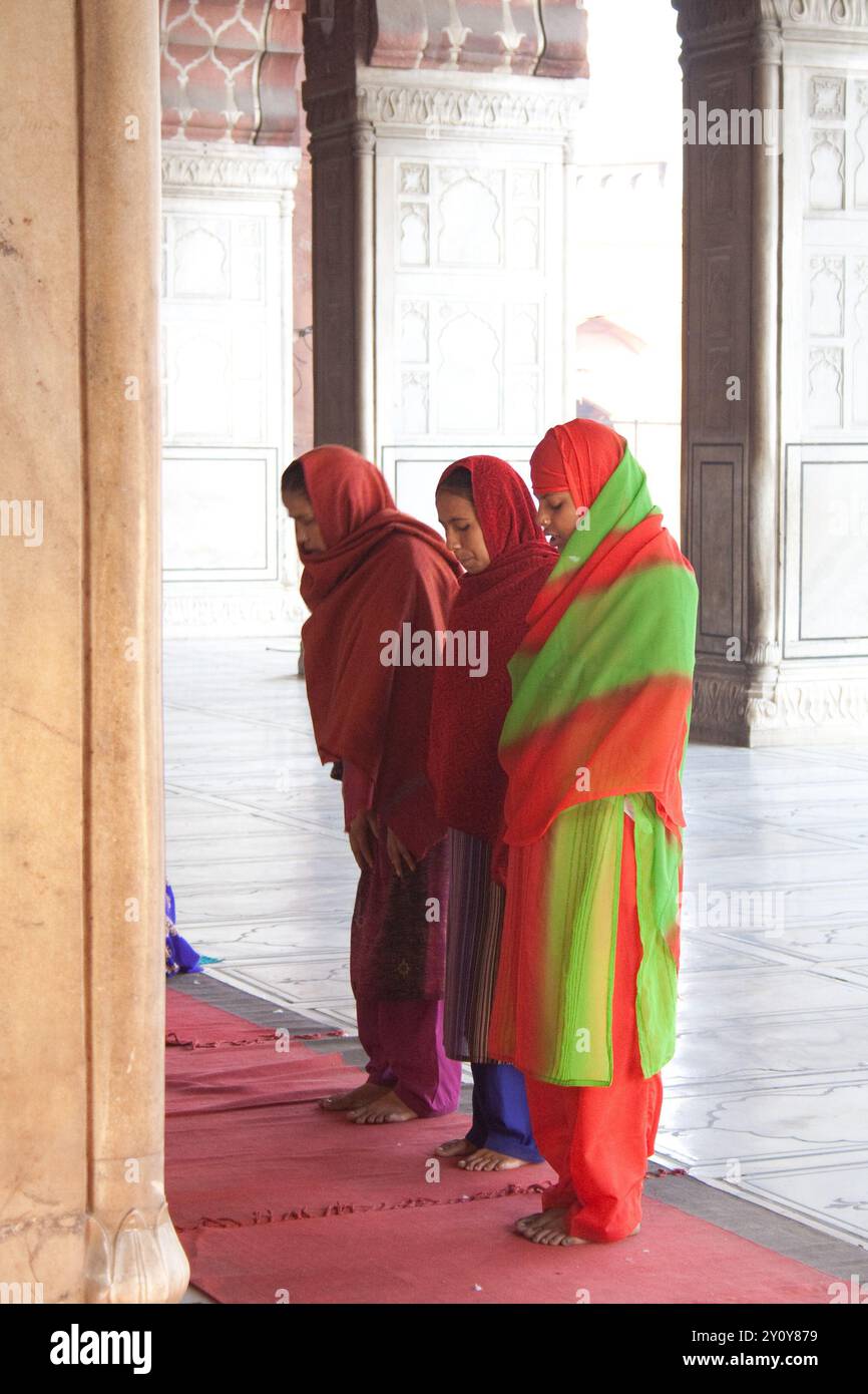 Modestly-dressed woman praying in mosque; Delhi; India; brightly ...