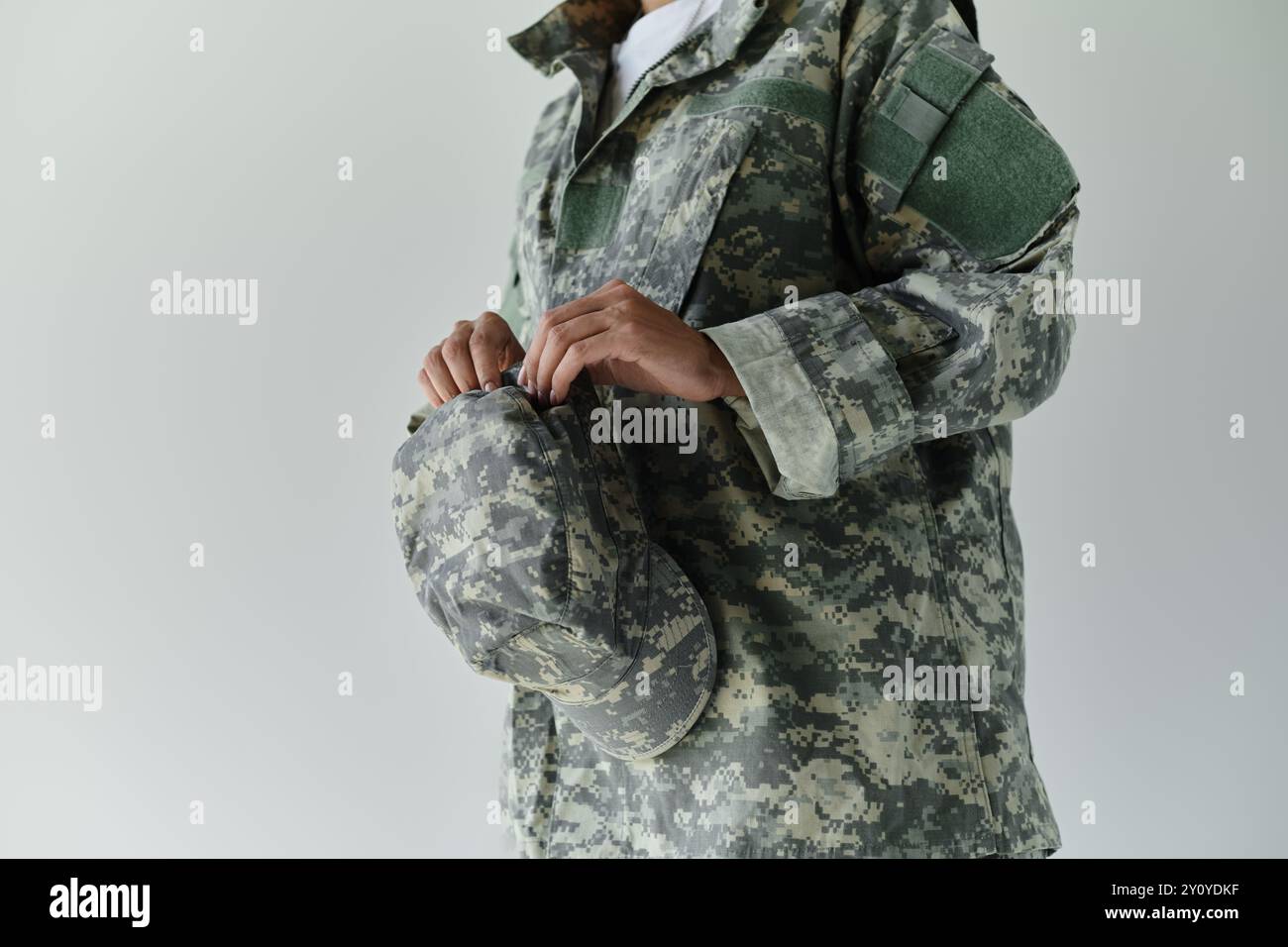 A dedicated female soldier adjusts her gear, showcasing pride in her ...