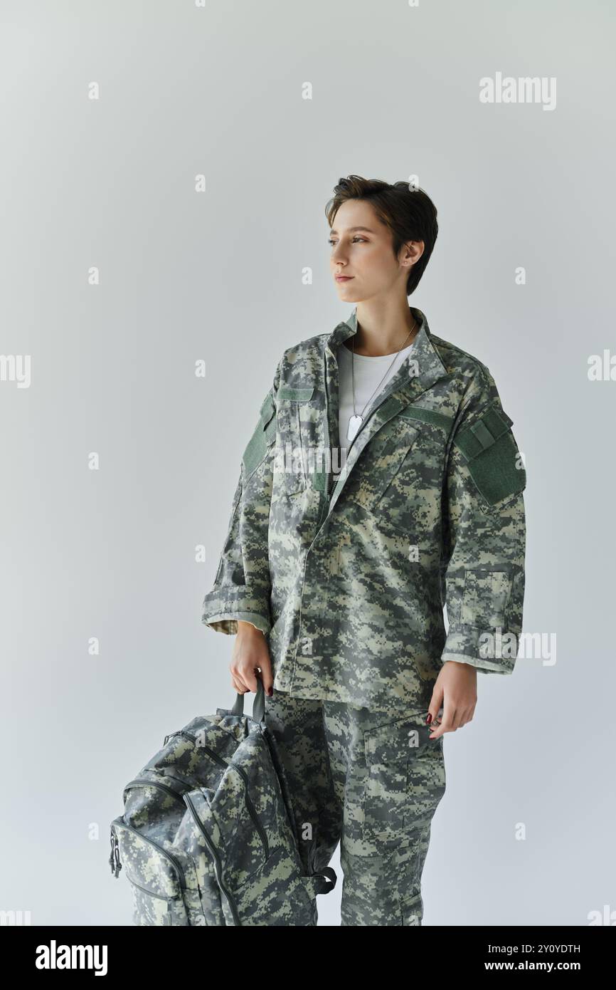 A young woman in military uniform standing before deployment Stock ...
