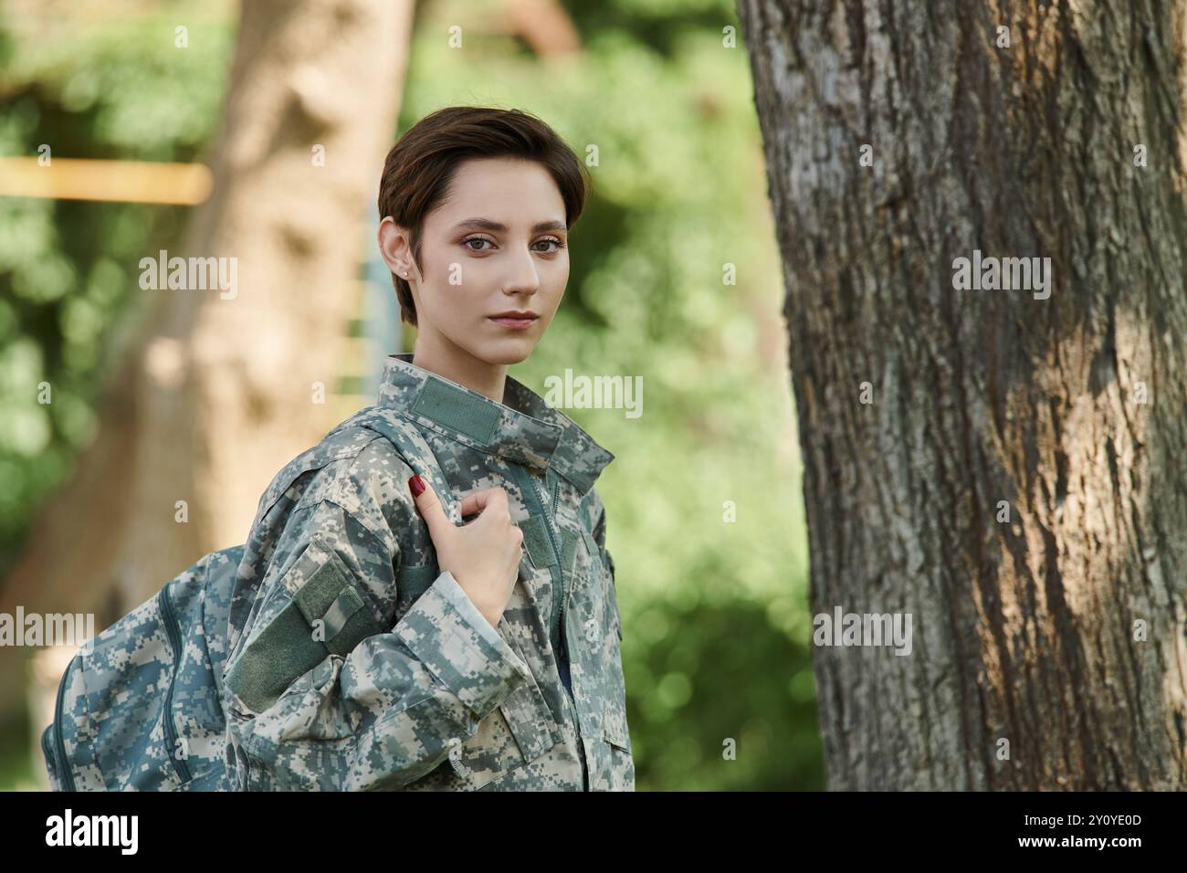 A soldier with short hair beams with pride as she returns home to a welcoming outdoor setting ...