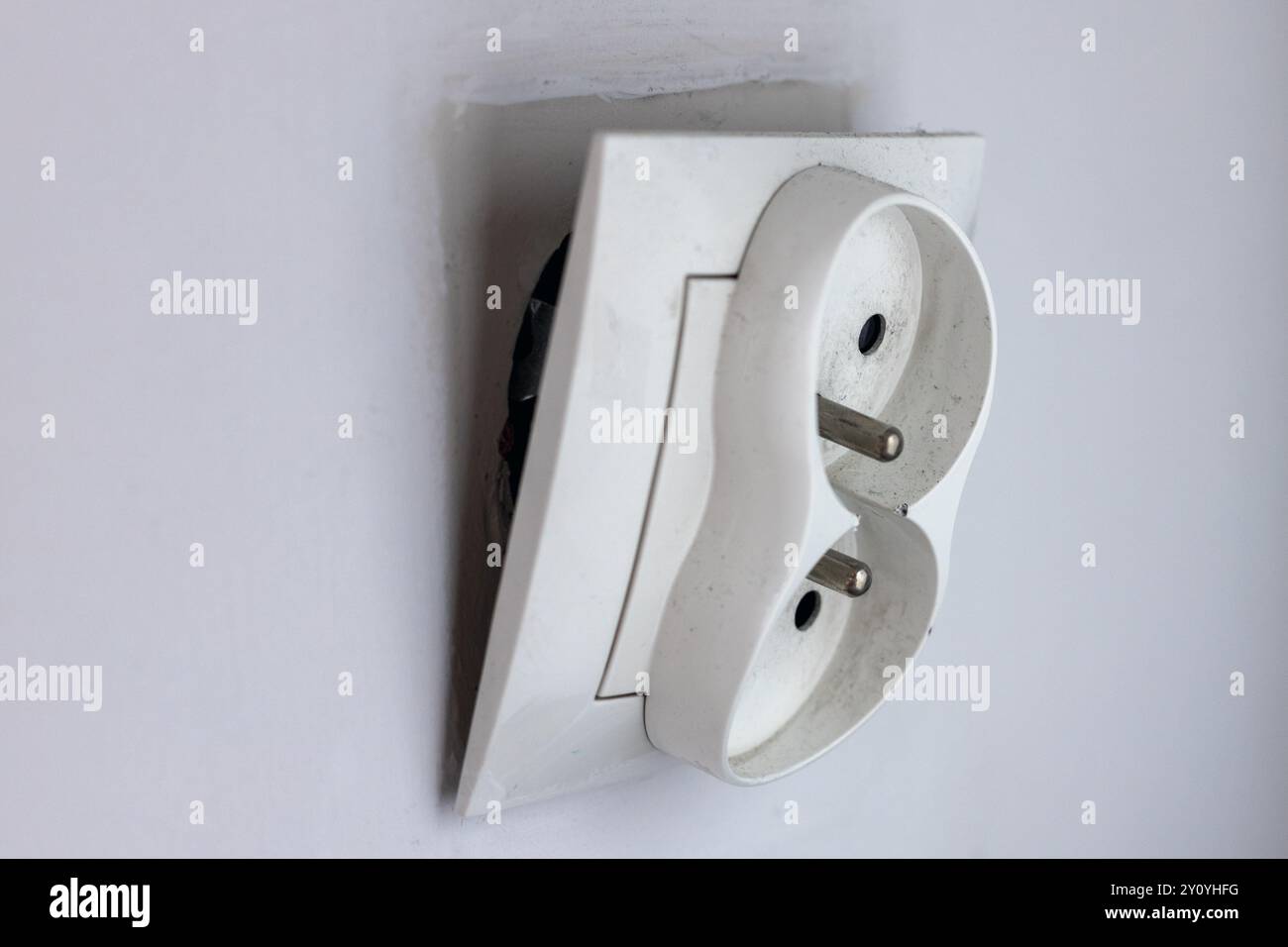 White Power Outlet on Wall Defect Stock Photo - Alamy