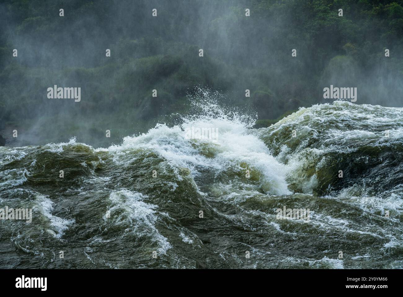 A detaied image of water going over the falls at Iguazu Falls National ...