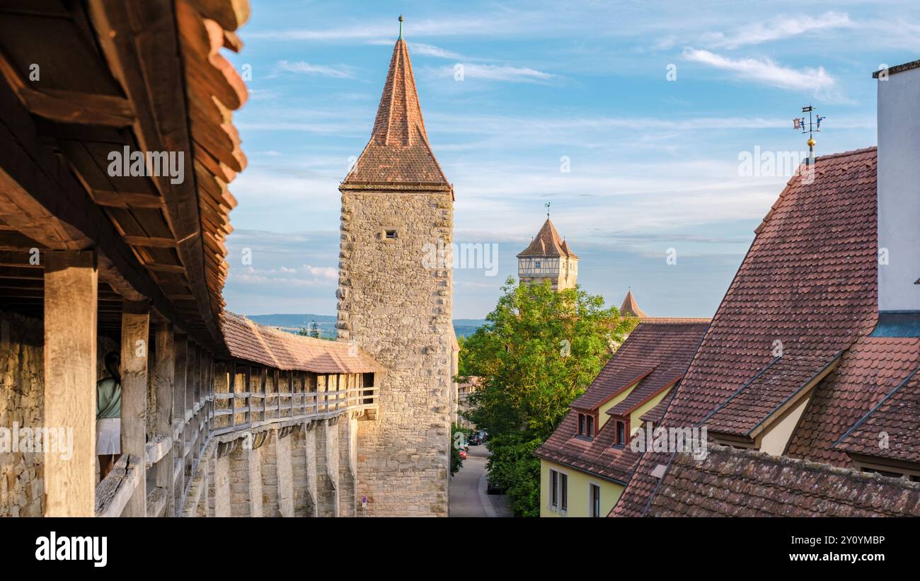 Visitors to Rothenburg ob der Tauber stroll through picturesque streets ...