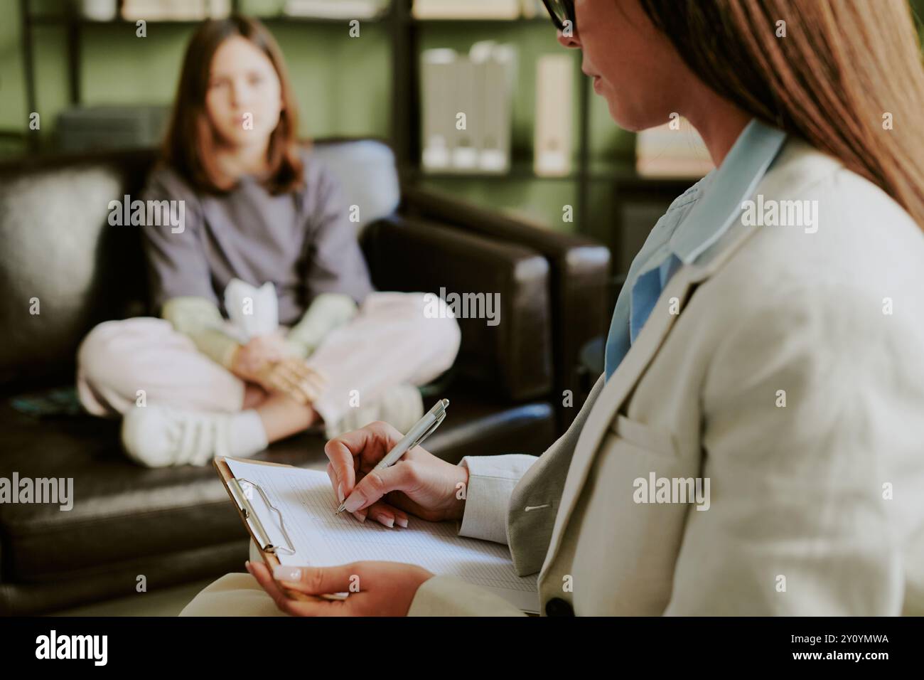 Counseling Session With Therapist Taking Notes on Clipboard Stock Photo ...