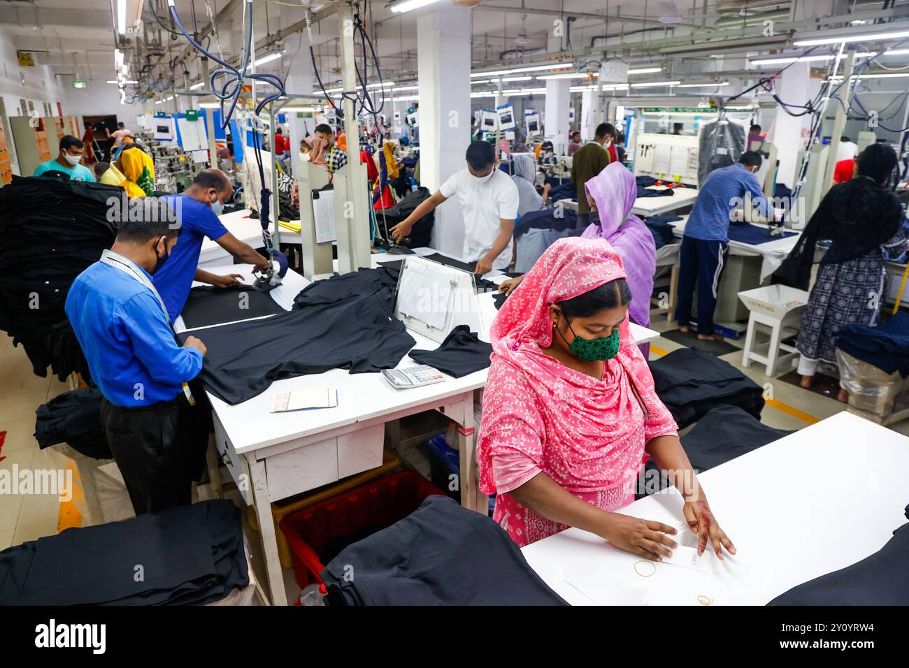 Garment workers are working at the factory , in Dhaka, Bangladesh, July ...