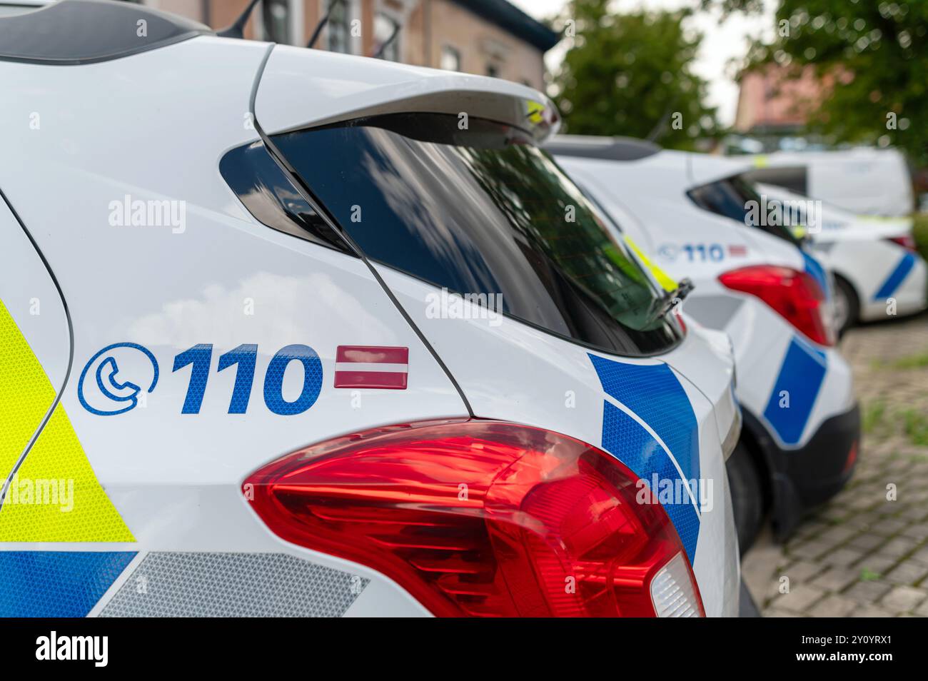 Fleet of police cars parked outside a station with visible emergency ...