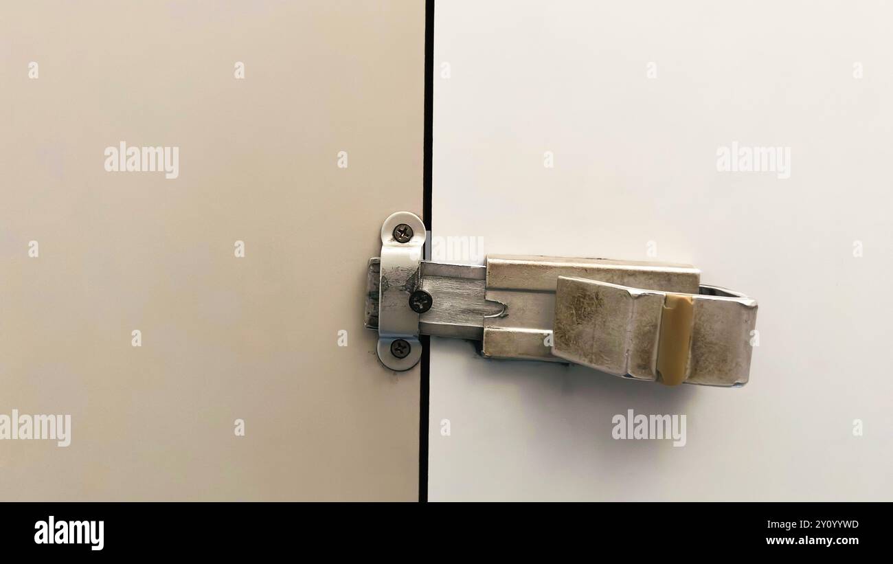 Close up of a metal latch securing two doors together. The image ...