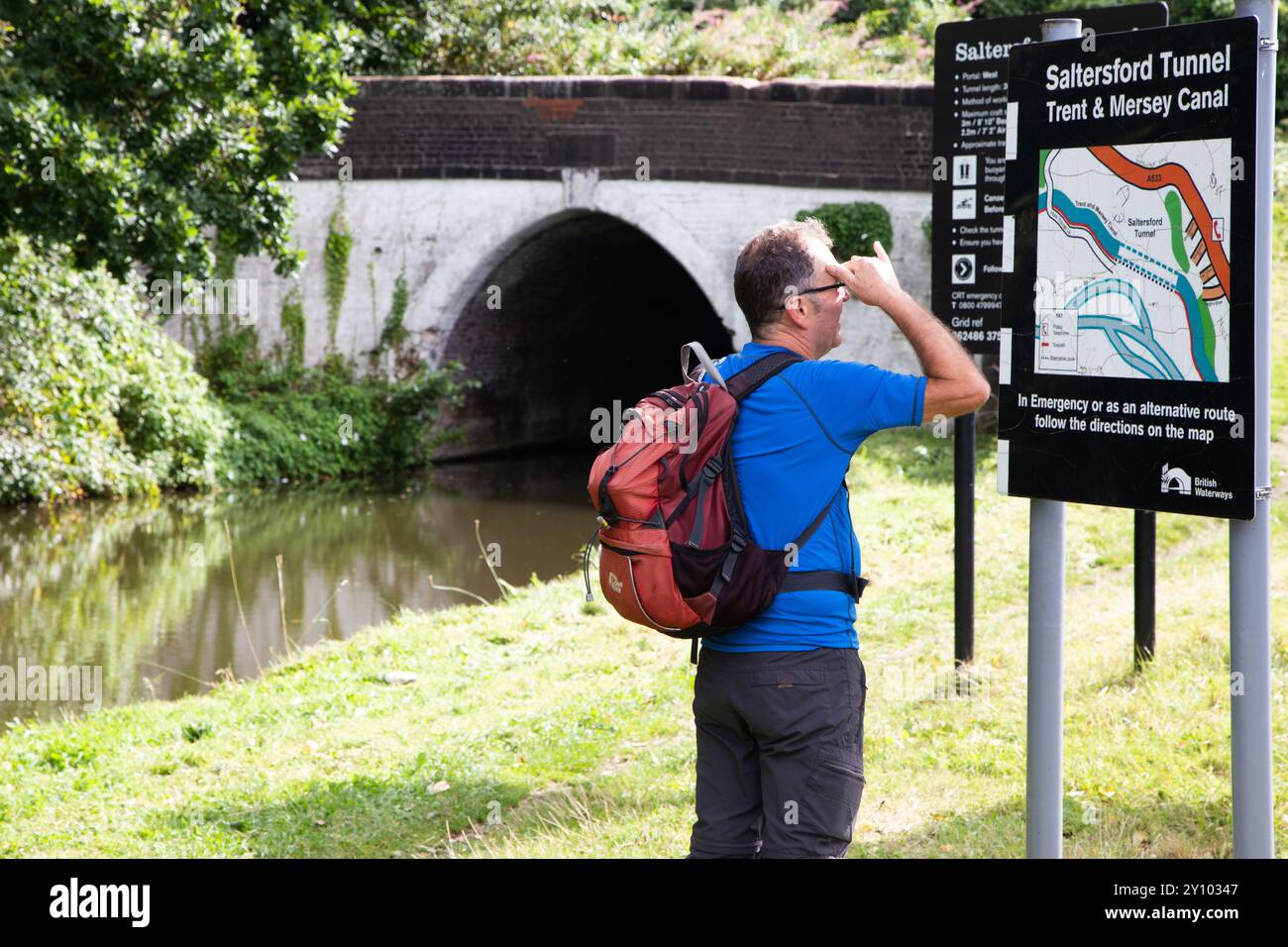 Man reading the notice board at the Western end of the Saltersford ...