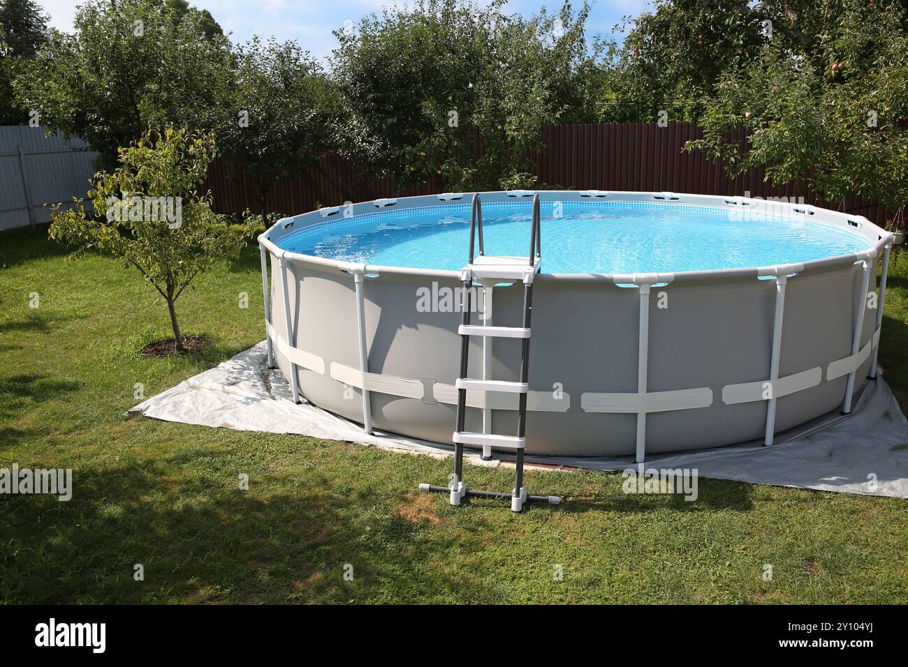 Above ground swimming pool outdoors on sunny day Stock Photo - Alamy