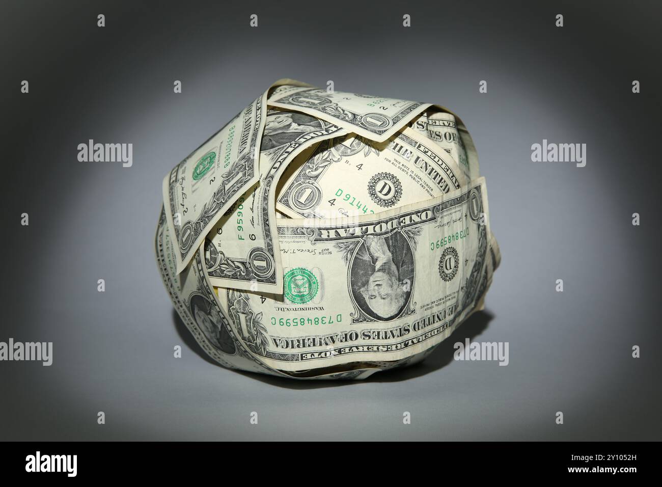 Ball made of dollars on grey background Stock Photo - Alamy