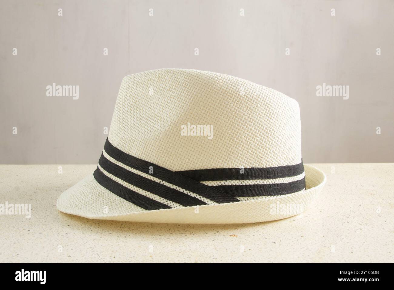 Black ribbon straw hat side view on grey horizontal table Stock Photo ...