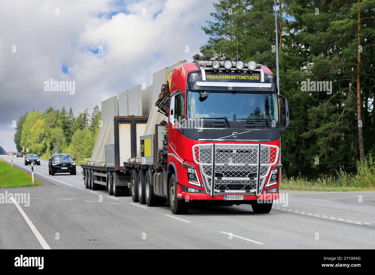 Red Volvo FH truck and trailer transporting tall precast concrete ...