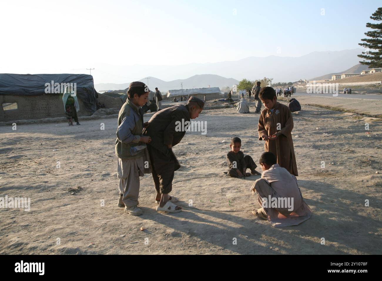 Children playing in a refugee camp in Kabul Stock Photo - Alamy