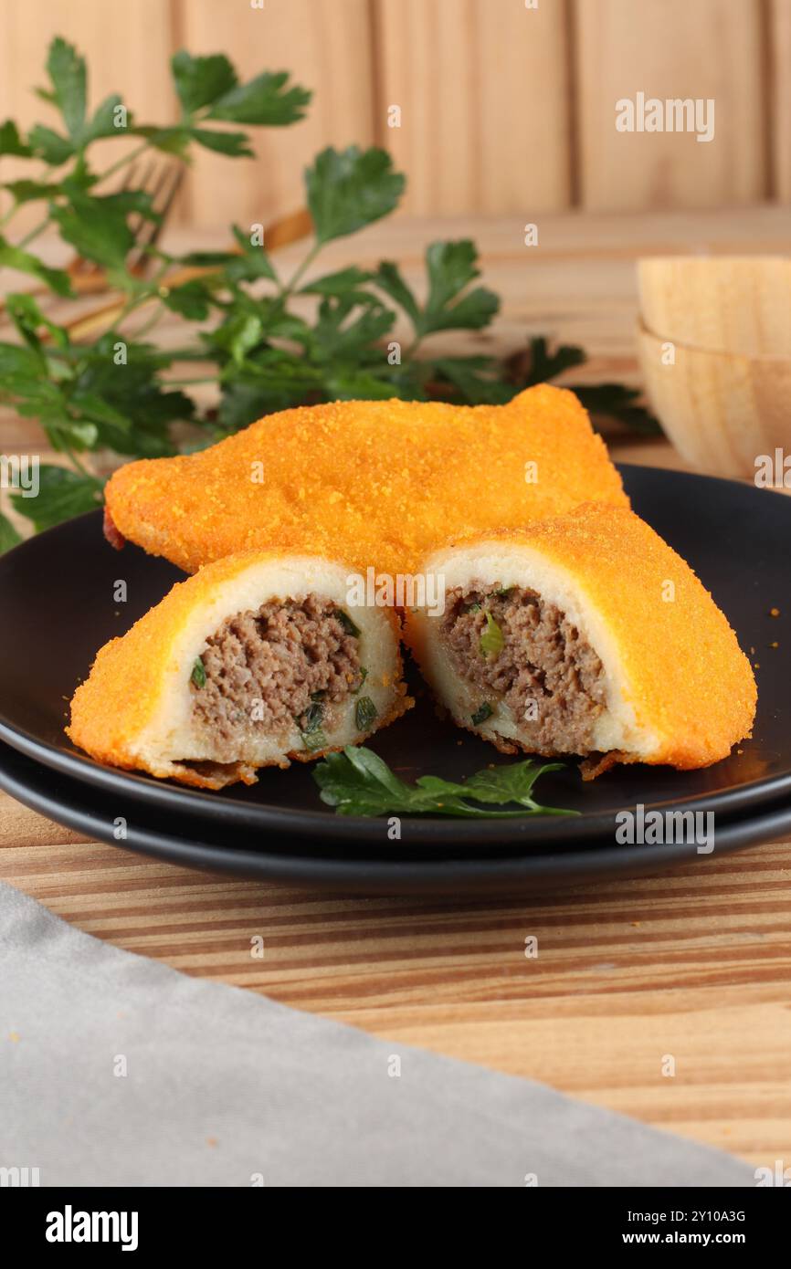fried pastry and baked pastry, stuffed with meat and presented on a ...