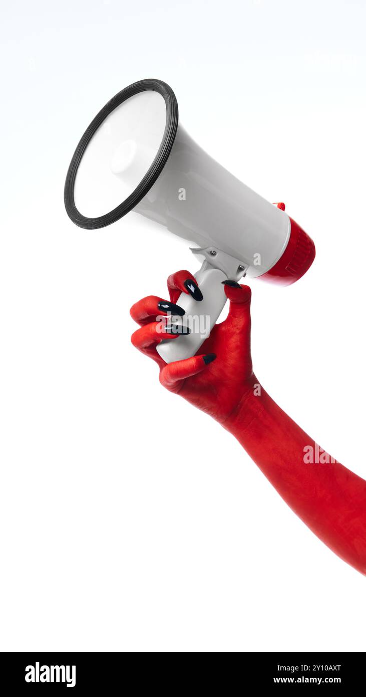Horror red devil's hand with blank long nails holding megaphone against ...