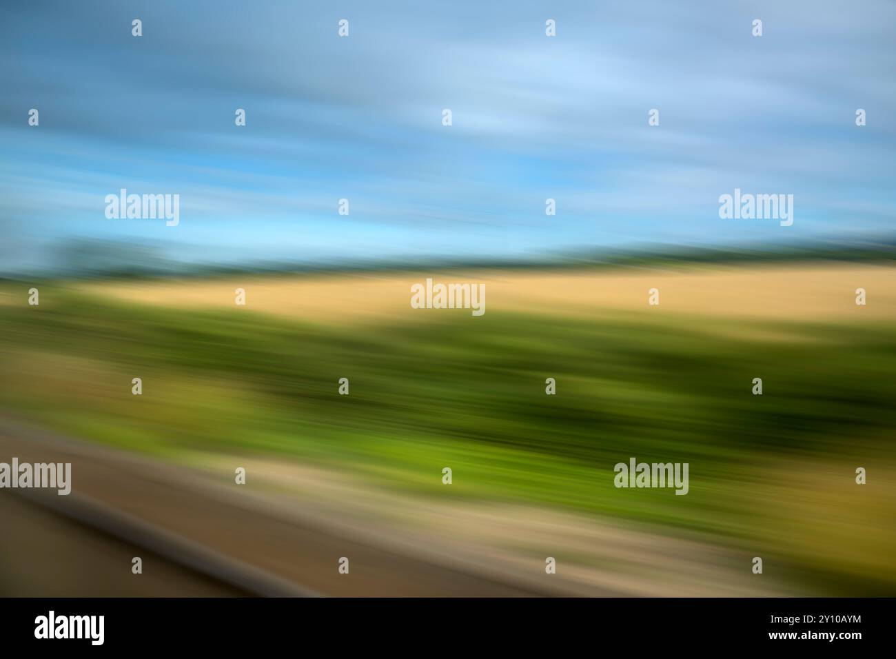 Abstract blurring of train line and field Stock Photo - Alamy