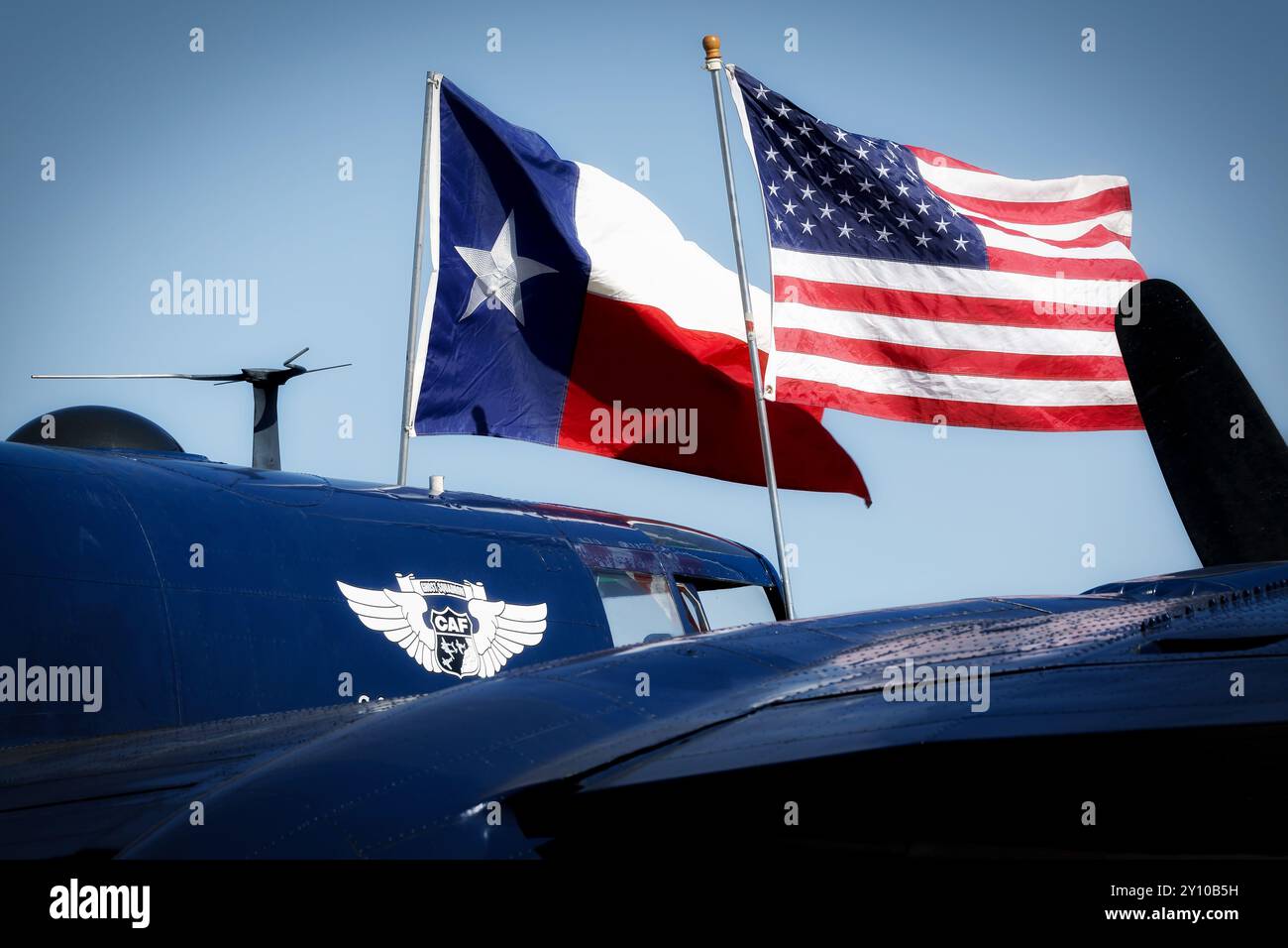 Flags fly above Devil Dog, a B-25 Mitchell bomber of the Commemorative ...