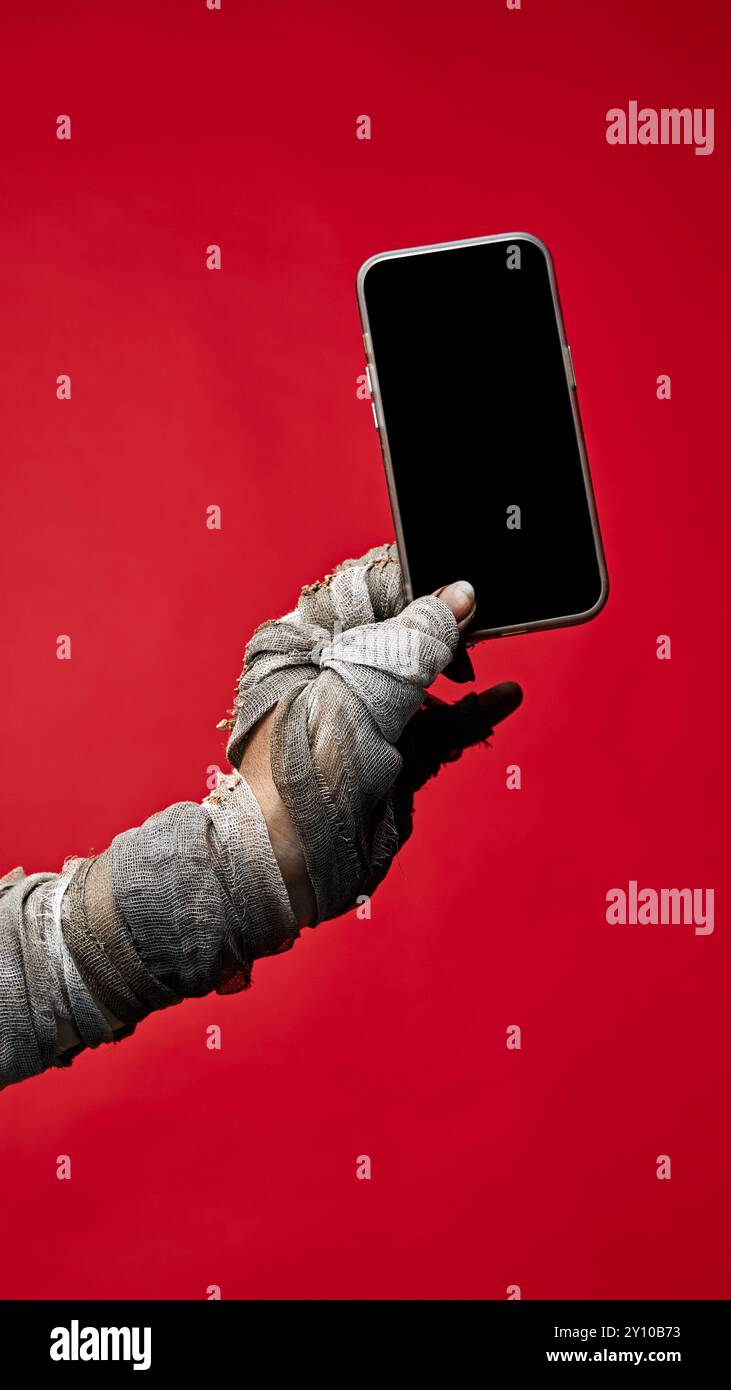 Terrifying hand, monster's hand holding digital smartphone with blank ...