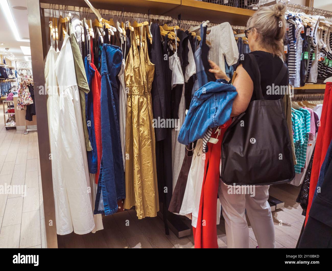 Shopper browses clearance merchandise in an Old Navy store in New York ...