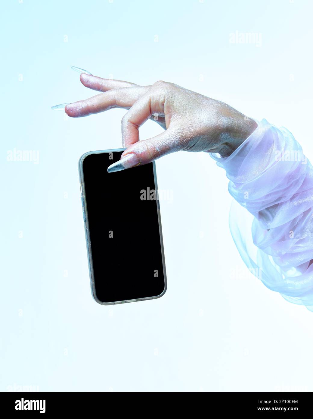 Hand of spooky white ghost holding smartphone with blank screen against ...