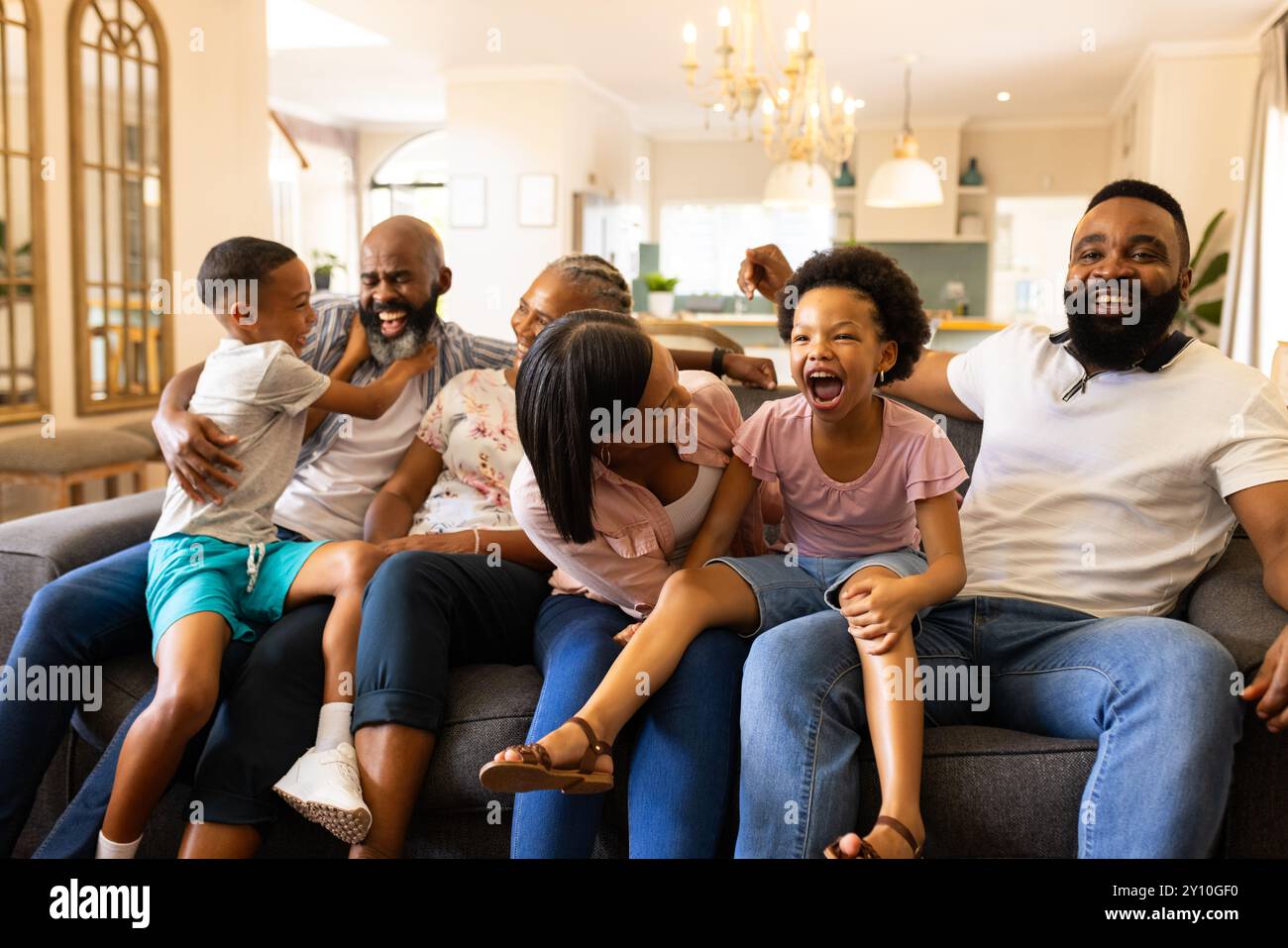 Laughing together diverse grandparents child hi-res stock photography ...
