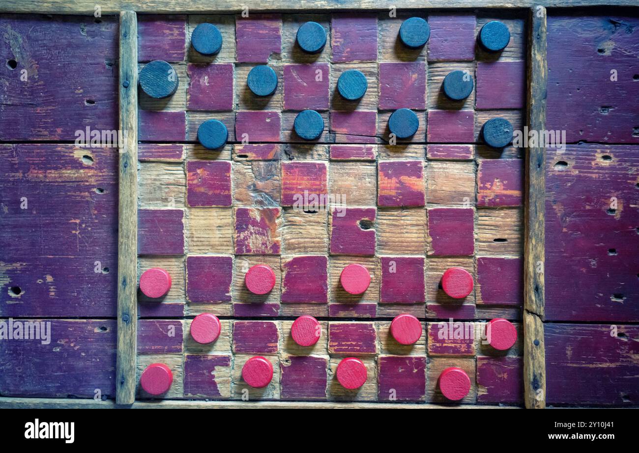 An old wood checkerboard displayed in Dallas Heritage Village. Lights ...