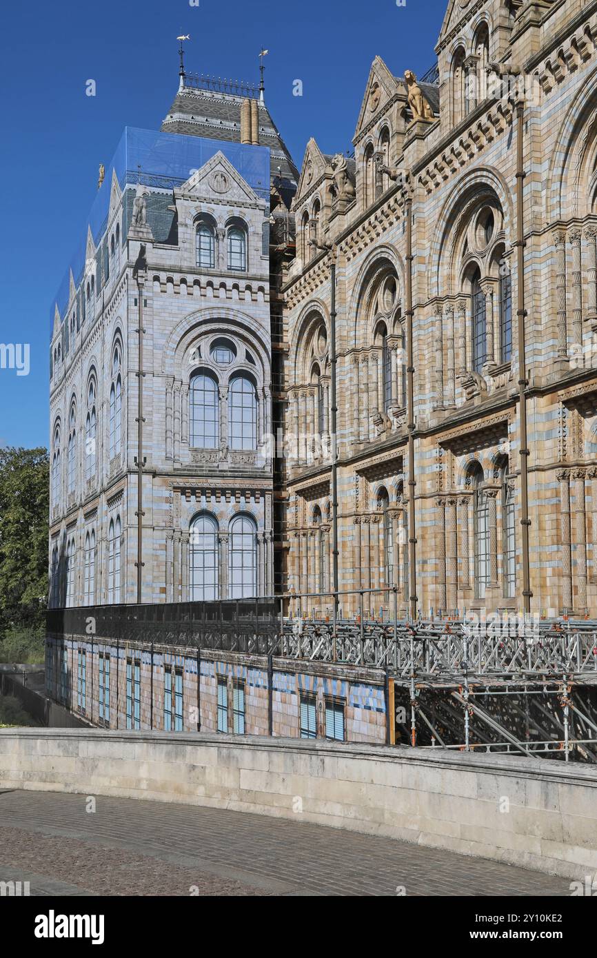 London's Natural History Museum is partially hidden by scaffolding covered in printed sheeting ...