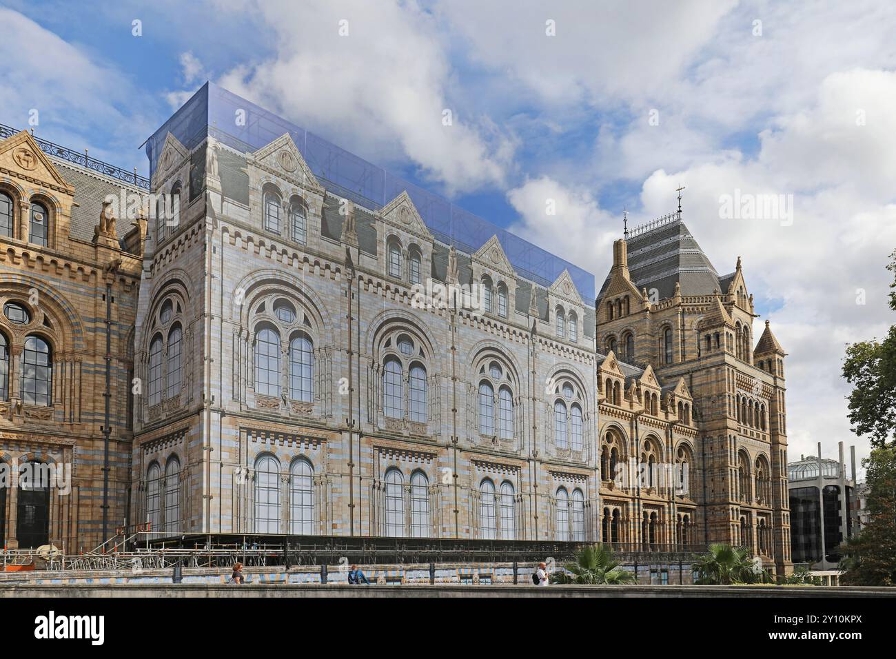 London's Natural History Museum is partially hidden by scaffolding covered in printed sheeting ...