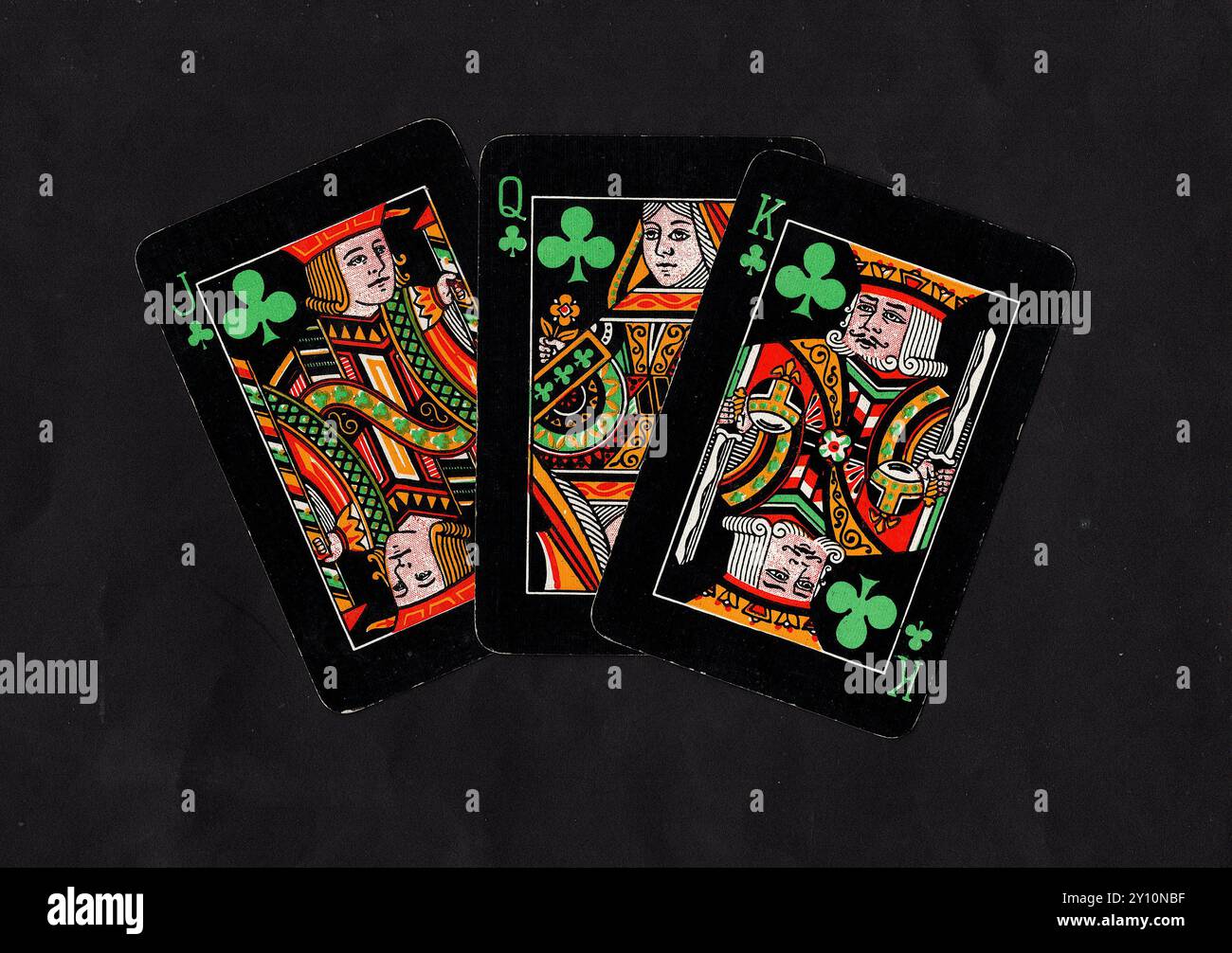 Vintage black playing cards showing a jack, queen and king of clubs on ...