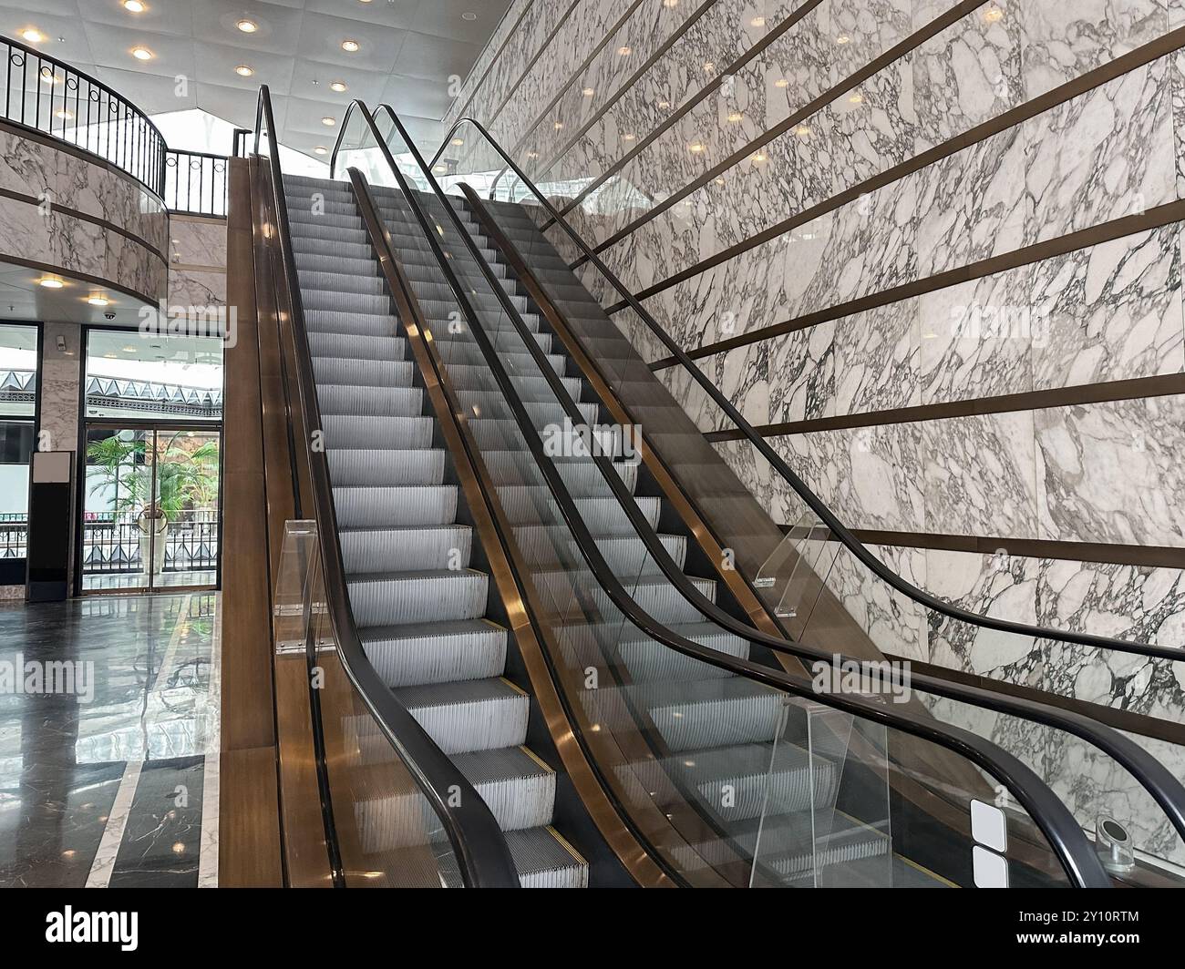 Modern escalators with handrails in shopping mall Stock Photo - Alamy